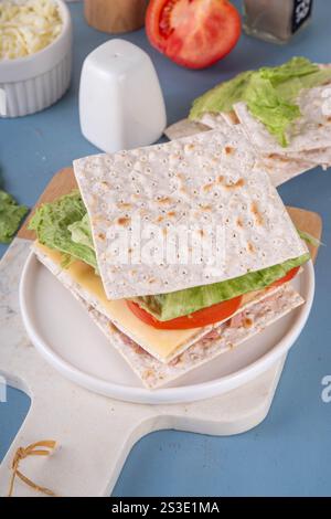 Tasty matzah sandwich with tuna, cheese, lettuce and vegetables. Viral ...