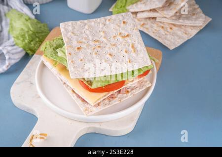 Tasty matzah sandwich with tuna, cheese, lettuce and vegetables. Viral ...