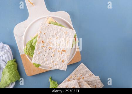 Tasty matzah sandwich with tuna, cheese, lettuce and vegetables. Viral ...