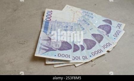South korean banknotes spread out on a concrete surface showcasing ...