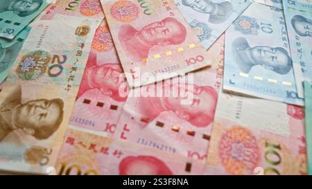 Chinese yuan banknotes scattered, showcasing various denominations and ...
