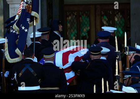 A joint services body bearer team carries the flag-draped casket of ...