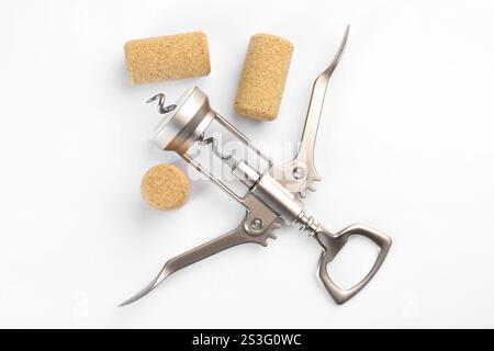 Wing corkscrew and corks on white background, top view Stock Photo - Alamy