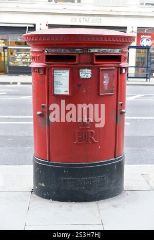 Red letterbox on an empty London street, London, London region, England ...