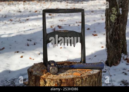 Log splitter and mallet in snow Stock Photo - Alamy