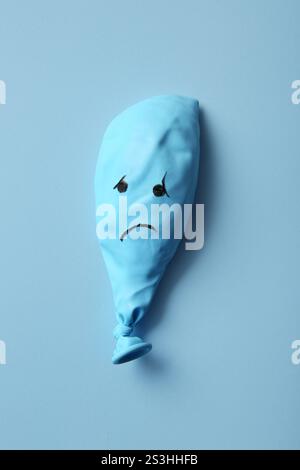 Air balloon with drawn sad face on white background. Space for text ...