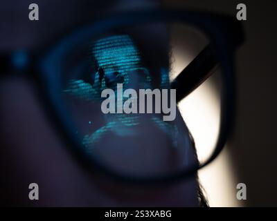 An hackers ASCII skull and crossbones image reflected in the lens of a ...
