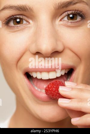 Woman, mouth and raspberry for skincare nutrition, dermatology or diet ...