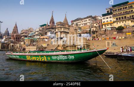 View of historical architecture along the riverbank with colorful boats ...