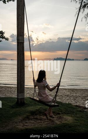 Woman sunset coastal scenery enjoying the peaceful evening view from a ...