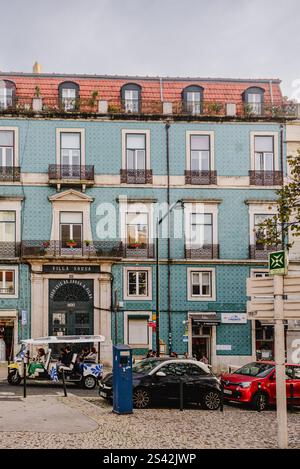Vibrant city street with traditional tiled buildings, tourist services ...