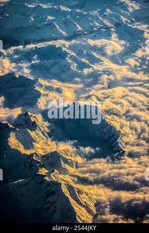 Snowy mountains from above with white clouds Stock Photo - Alamy