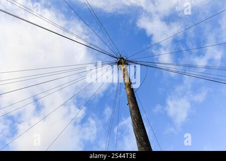 Looking up at BT Open Reach Telegraph Pole and telephone cables with ...