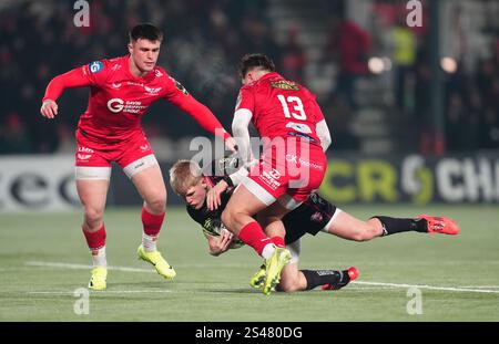 Gloucester's George Barton is tackled by Scarlets' Macs Page during the ...