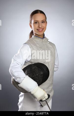 Fencer with epee on gray background. Combat sport Stock Photo - Alamy