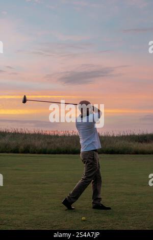 a golf player making a swing on a vibrant beautiful golf course Stock ...