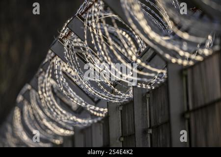 Symbolic image security, S-wire rolls, NATO wire, on a fence top ...