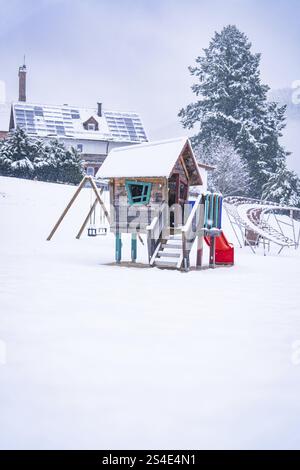Playground with swings, covered with snow on a Sunny winter day Stock ...