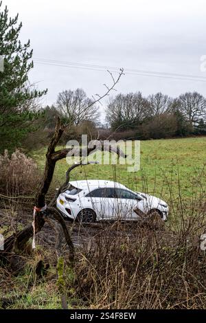Car crashed into farm field by missing T-junction Stock Photo - Alamy