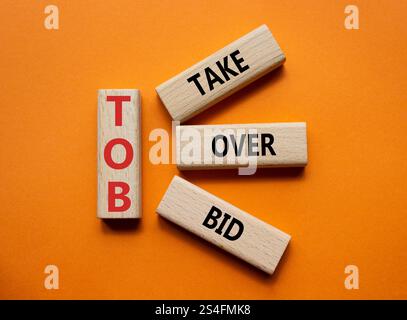 TOB - Take Over Bid. Wooden cubes with words TOB. Beautiful grey green ...