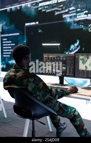 Army tech specialist in data center and coworkers using green screen ...