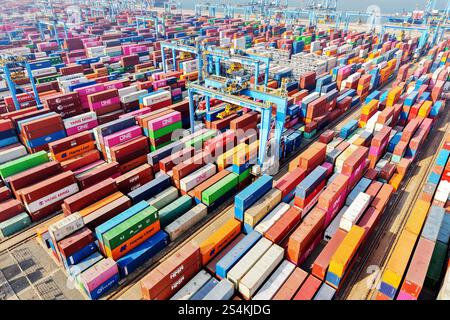 A busy foreign trade container terminal at Qingdao Port in east China's ...