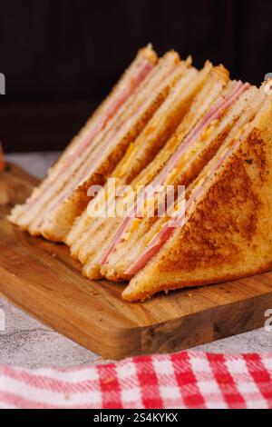 A tempting selection of ham and cheese sandwiches cut in half, stacked ...