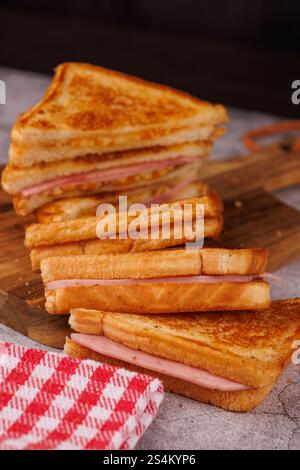 A mouthwatering display of ham and cheese sandwiches stacked vertically ...