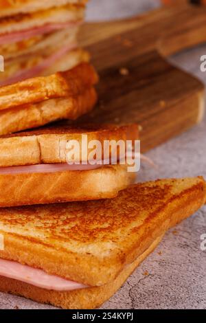 A charming arrangement of ham and cheese sandwiches, cut in half and ...