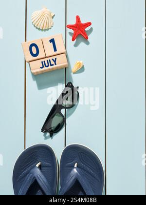 top view of wooden calendar with July sign, clay butterfly and pink ...