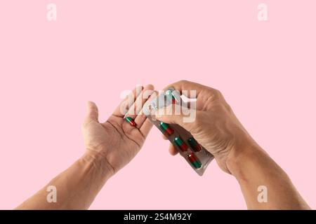 Closeup of male hand taking pink rose from a desk Stock Photo - Alamy