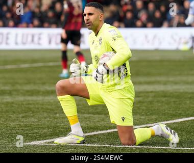 Tamworth, UK. 11th Jan, 2025. Dan Creaney of Tamworth challenges Radu ...