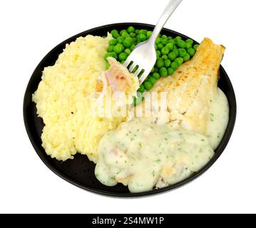 Cod fillet in parsley sauce with mash, peas and carrots Stock Photo - Alamy