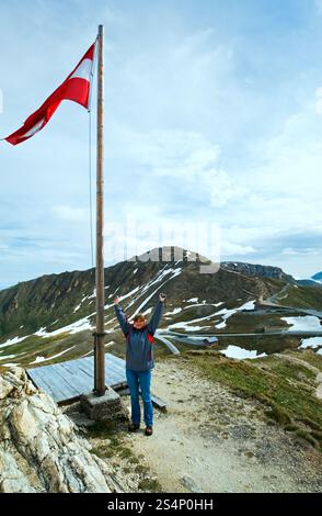Austrian Flag above Alps mountain and Grossglockner High Alpine Road ...