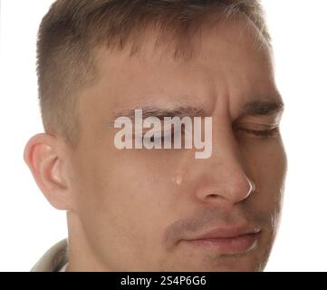 Distressed young man crying on white background Stock Photo - Alamy