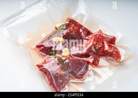 Beef Vacuumed with Rosemary cooked sous vide on a white background ...