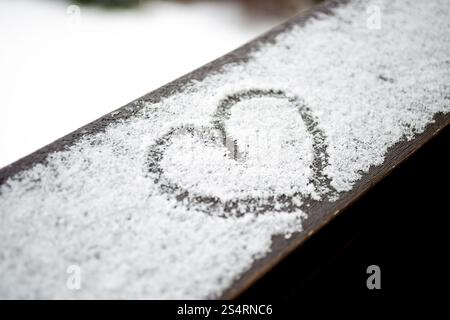 Heart symbol drawn on the snow, on winter day. Romance. Valentine's Day ...
