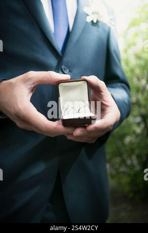Closeup view of Silver Diamond ring on brown heart with pink flower ...