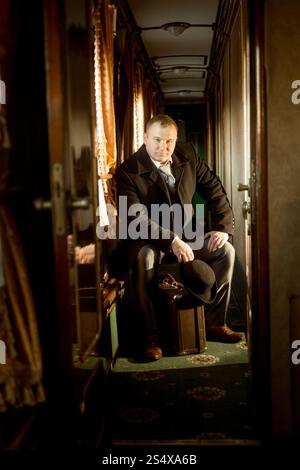 Photo of successful stylish man sit platform use modern netbook macbook ...