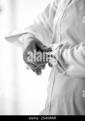 elegant black man adjusting cuff Stock Photo - Alamy