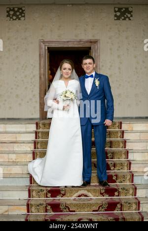 Beautiful newly-married couple posing in a park for the wedding ...