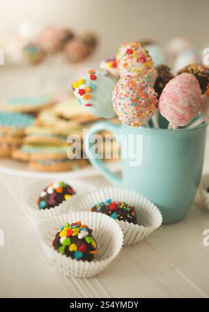 Tasty cake pops in cup, isolated on white Stock Photo - Alamy