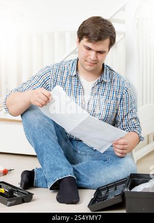 puzzled man sitting at the table room office work business finance ...
