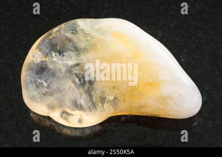 tumbled yellow Citrine gemstone on dark Stock Photo - Alamy