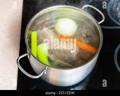 simmering meat stock in stockpot on ceramic cooker Stock Photo - Alamy