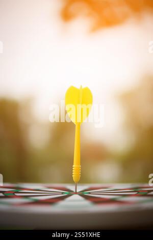 Red and yellow dart arrows hitting in the target center of dartboard ...