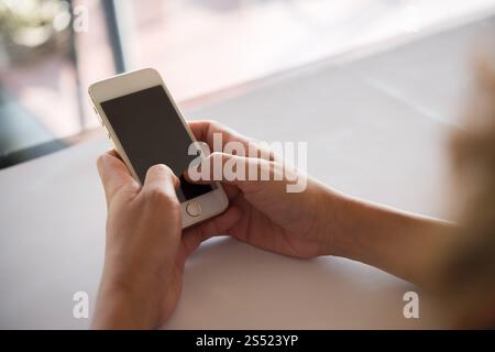 A Woman's hands with a cell phone. Copy space. Landscape orientation ...