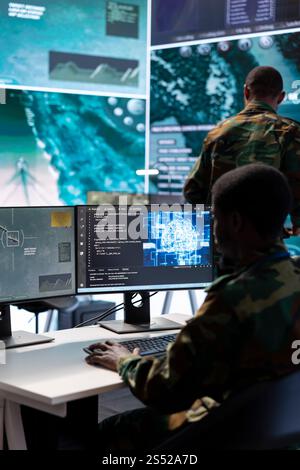 Drone operators in military data center supervising autonomous flight ...