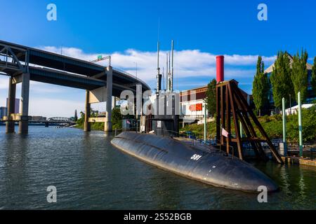 Submarine Docked by Waterfront Under a Clear Blue Sky and Modern Bridge ...