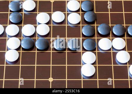 top view of gameplay of Go game on wooden board Stock Photo - Alamy
